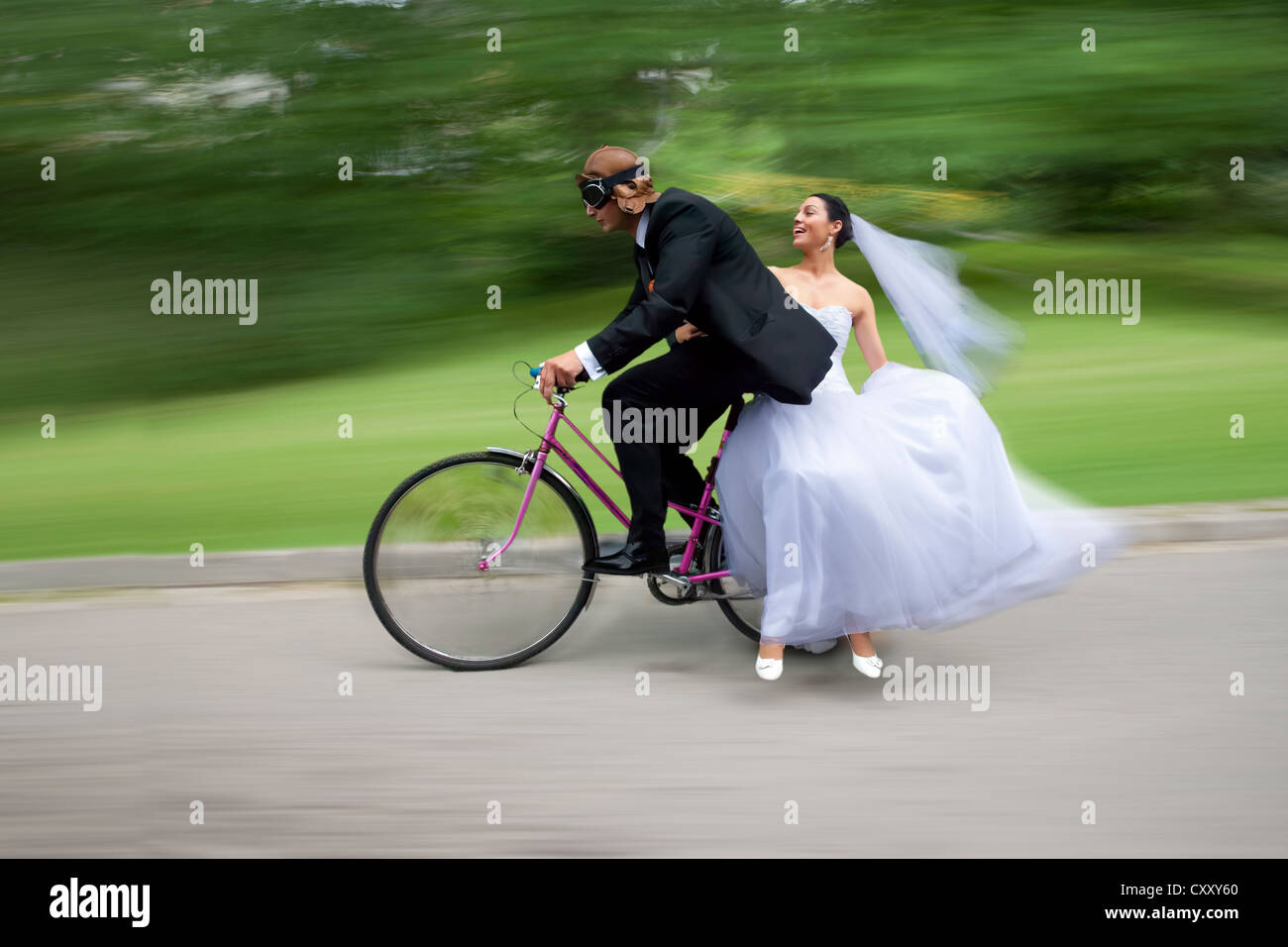 Bride and groom, bridal couple riding a bicycle Stock Photo - Alamy
