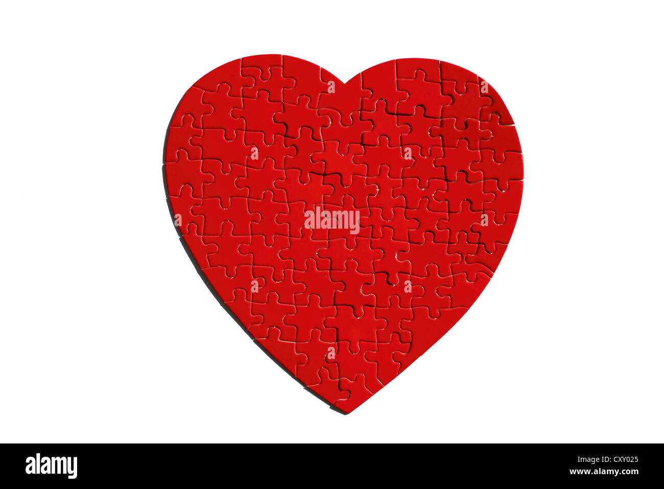 Red heart-shaped jigsaw puzzle, complete Stock Photo - Alamy