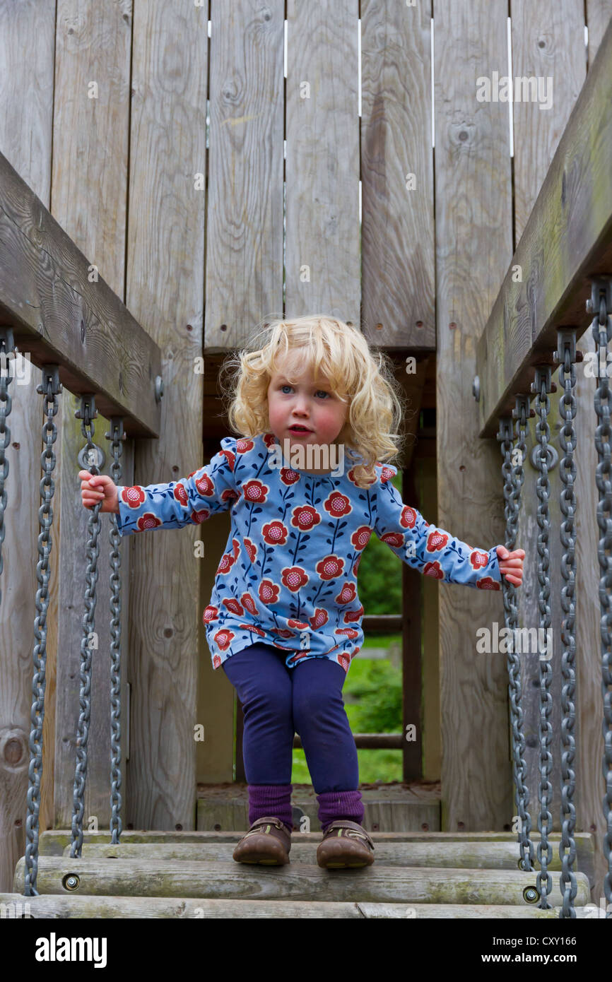 Young girl on a wooden climbing frame Stock Photo - Alamy