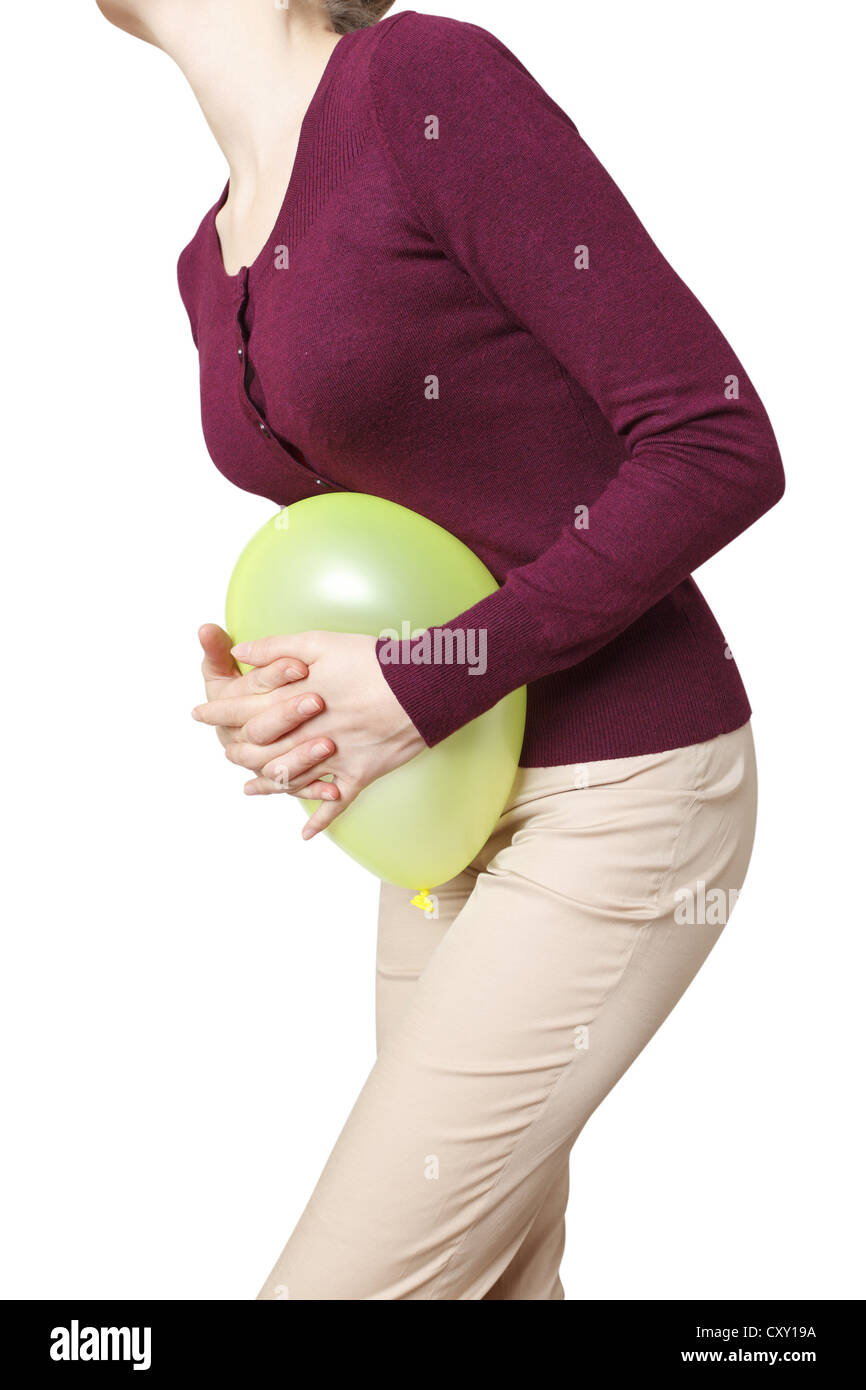 Woman pushing a balloon against her belly, symbolic image for abdominal ...