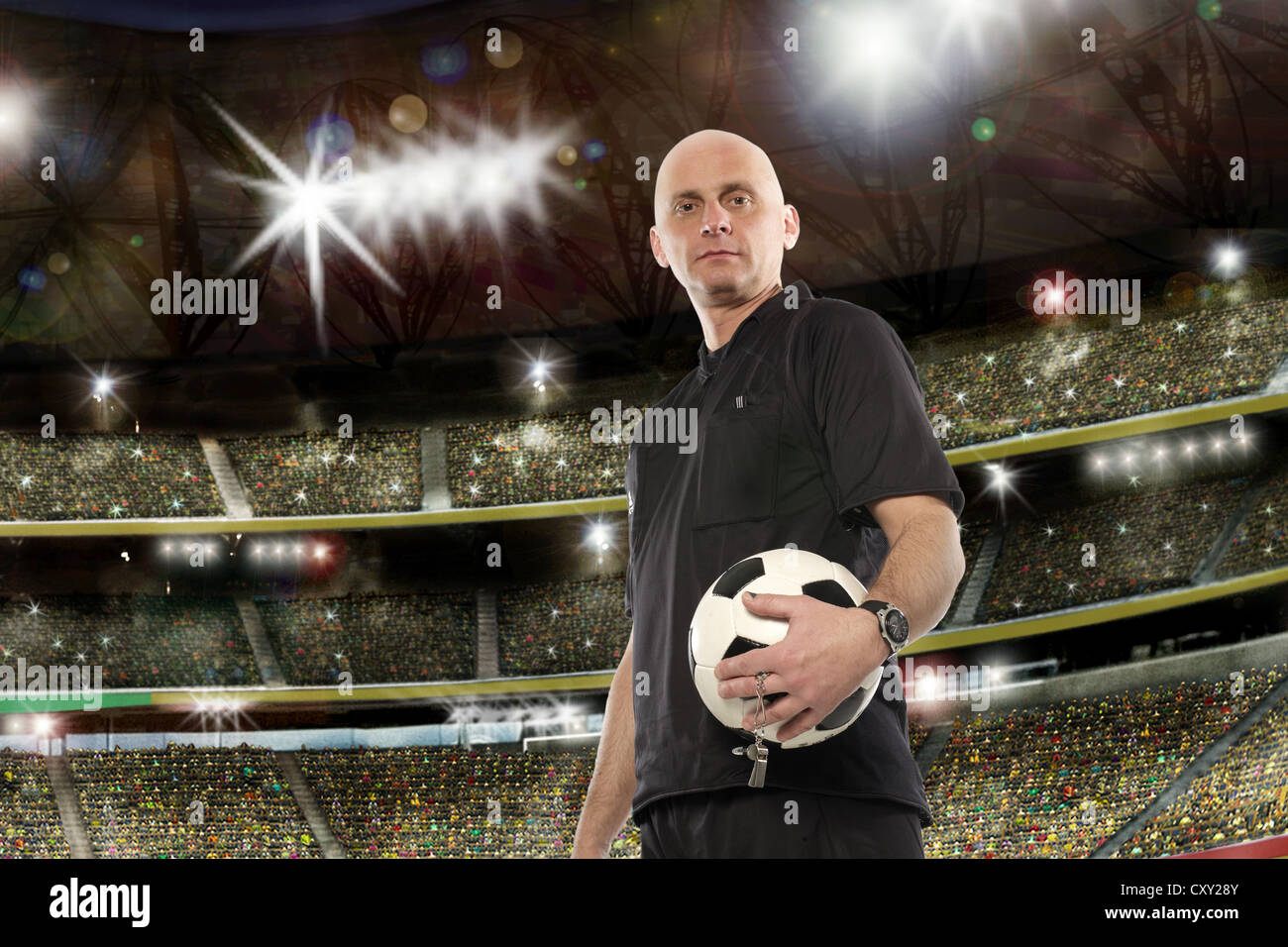Referee holding a soccer ball, soccer stadium Stock Photo - Alamy