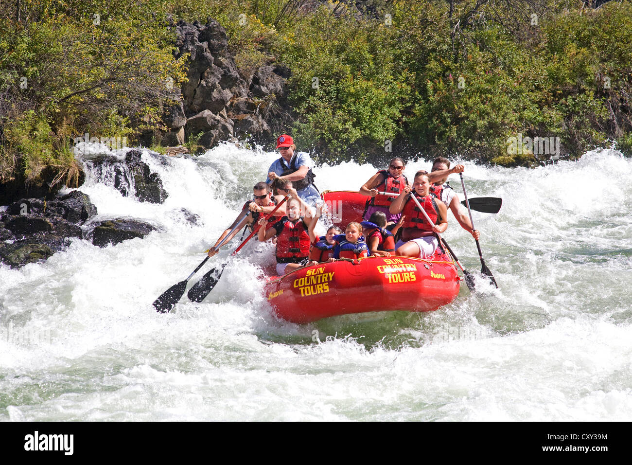 Whitewater rafters shoot the rapids of the Deschutes River in a paddle ...