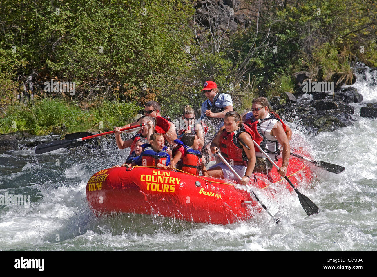 Whitewater rafters shoot the rapids of the Deschutes River in a paddle ...