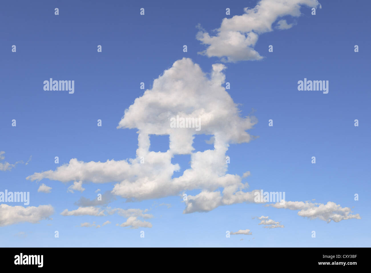 Cloud formations in the shape of a house against a blue sky ...