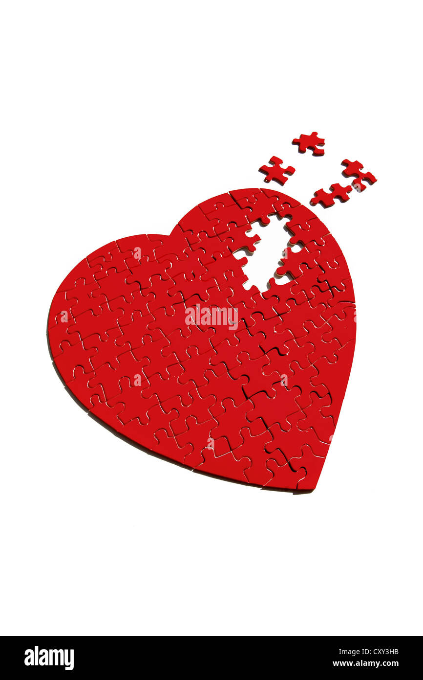 Red heart-shaped jigsaw puzzle, incomplete Stock Photo - Alamy