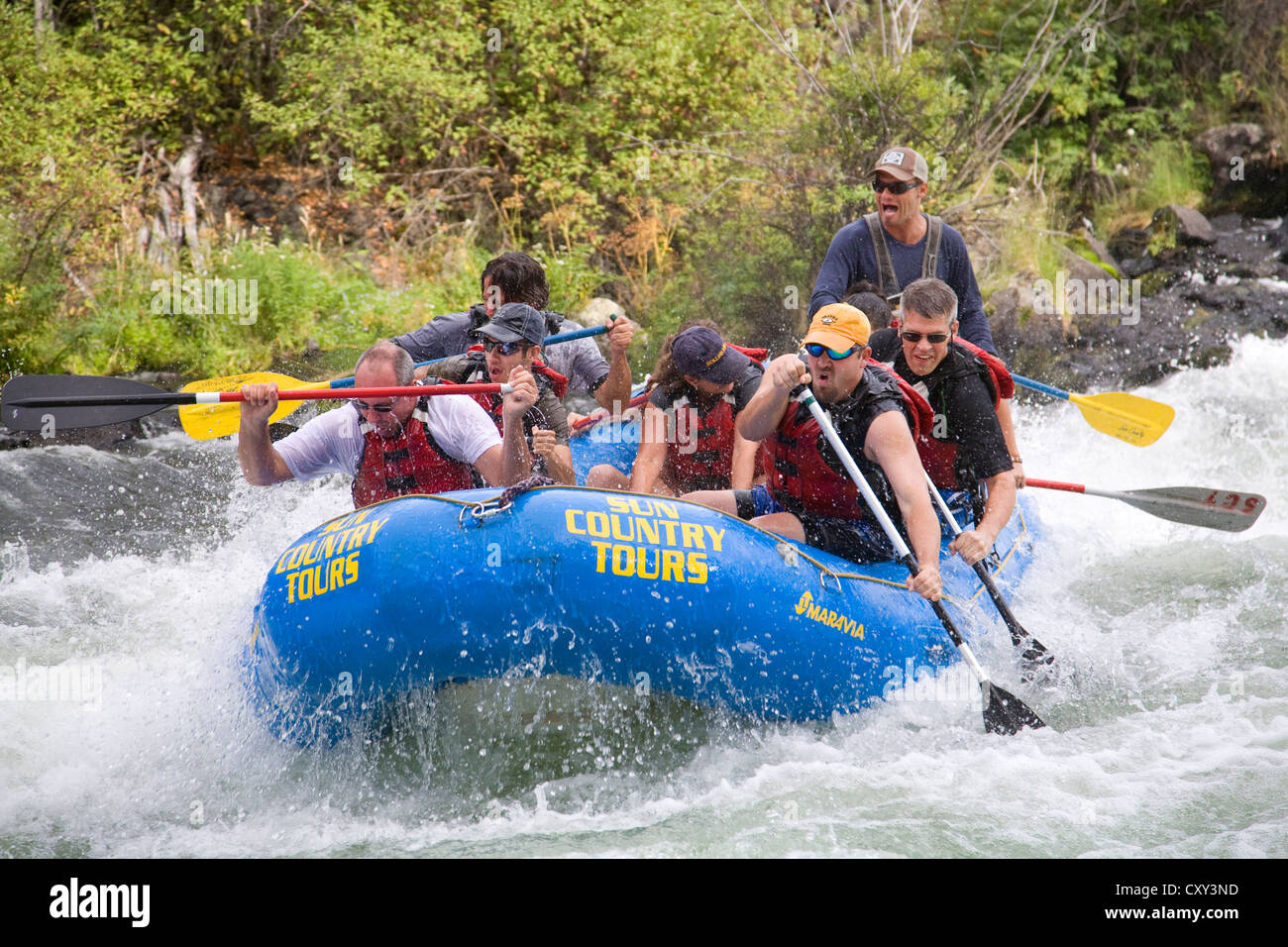 Whitewater rafters shoot the rapids of the Deschutes River in a paddle ...