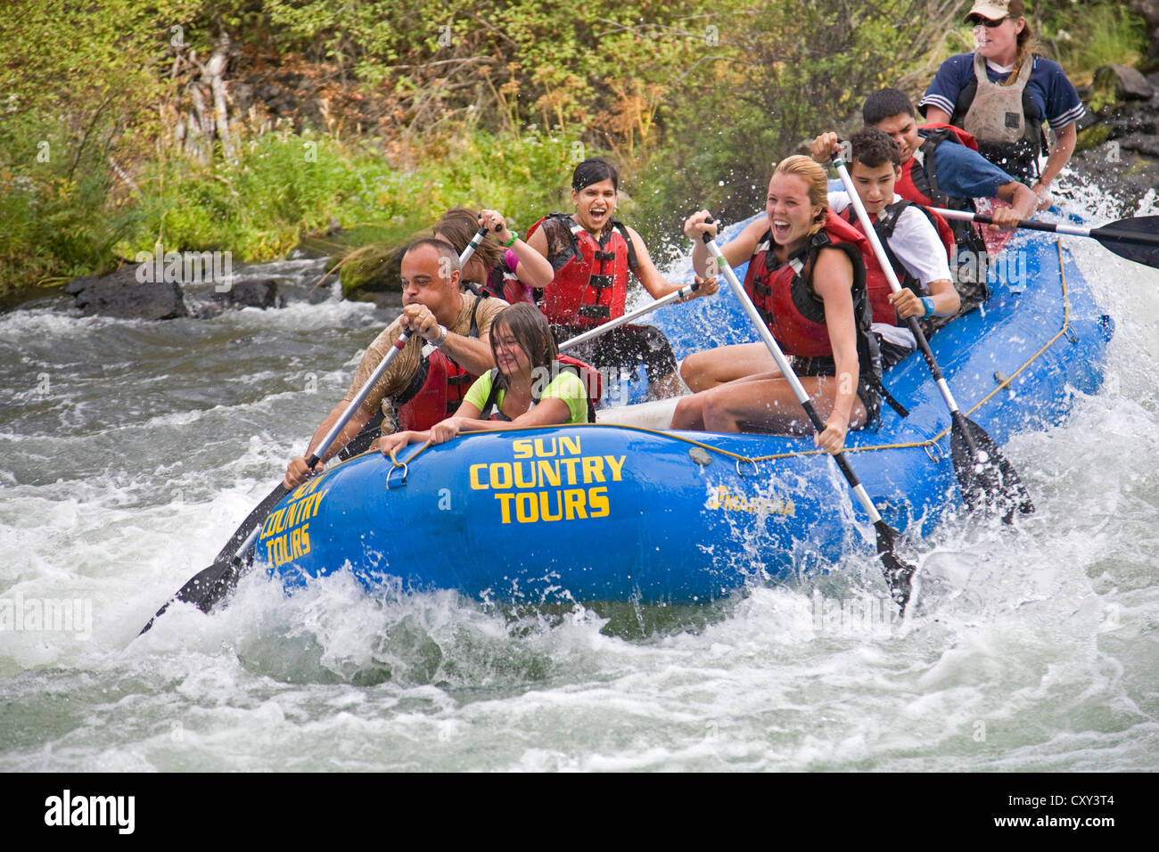 Whitewater rafters shoot the rapids of the Deschutes River in a paddle ...