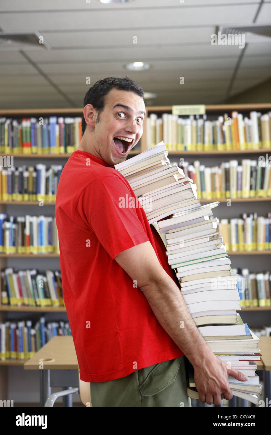 Man carrying huge pile of books hi-res stock photography and images - Alamy