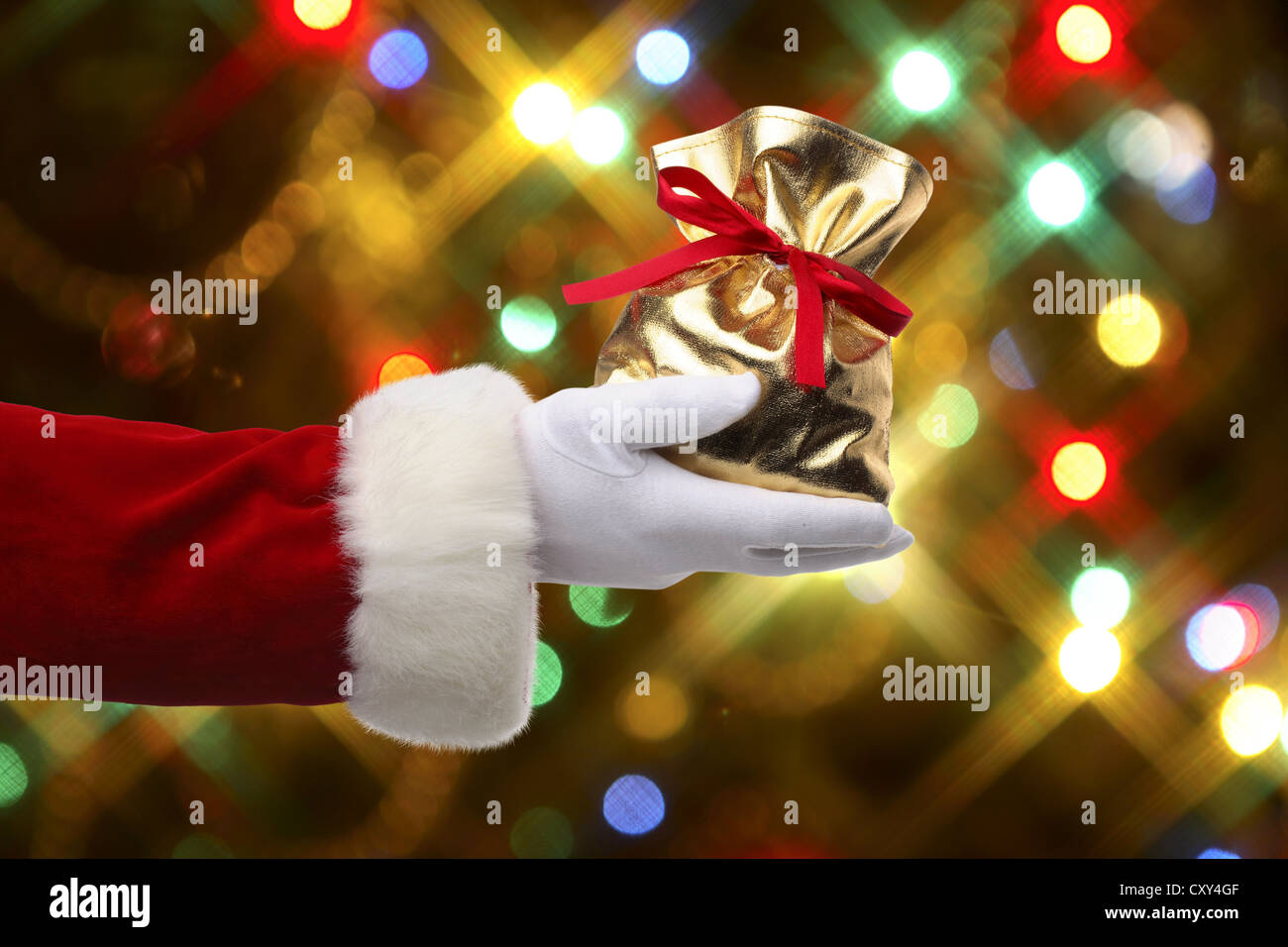 Santa Claus, detail of an arm handing over a Christmas present Stock ...