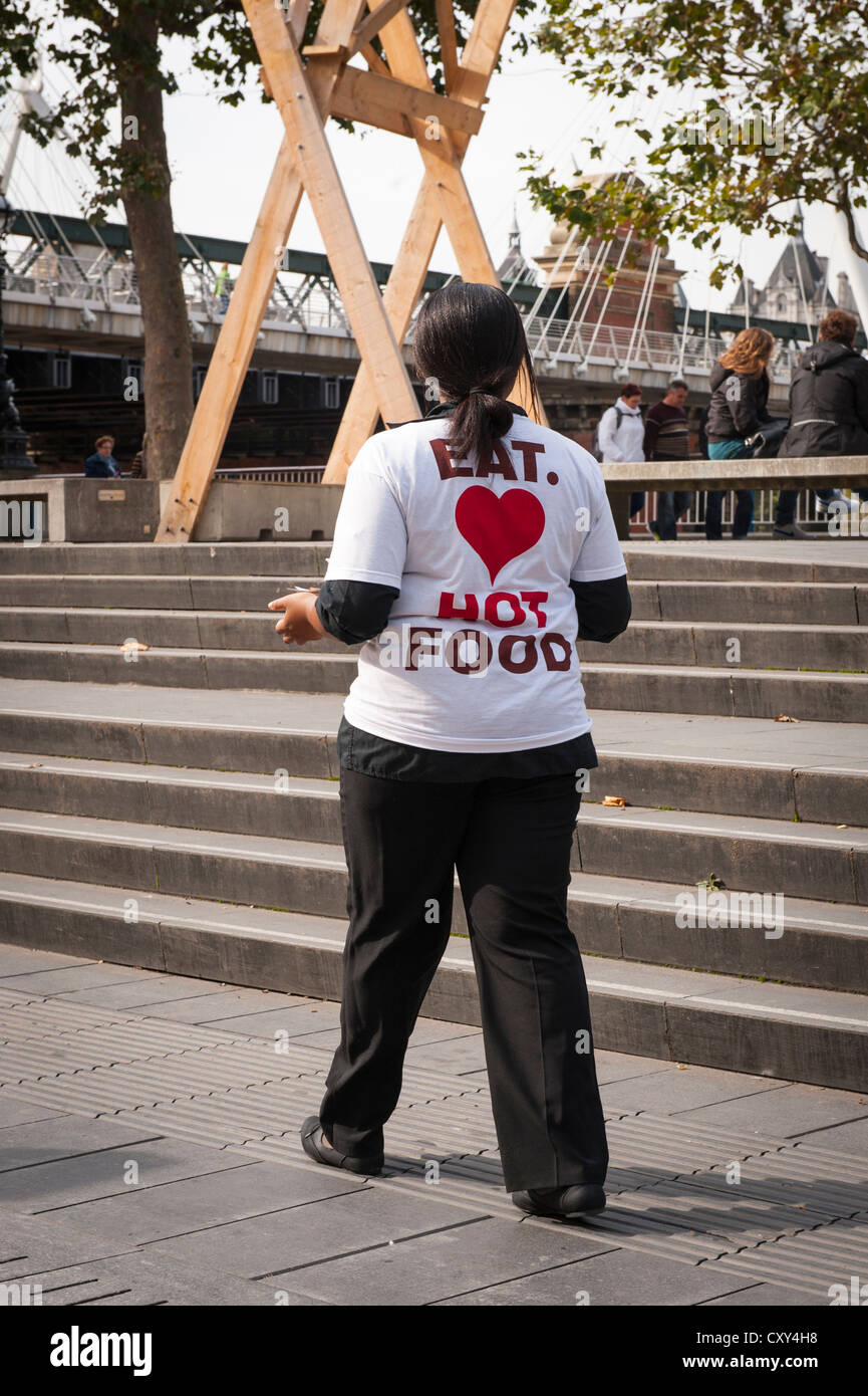 London Southbank Eat pretty young female black waitress ponytail hands ...