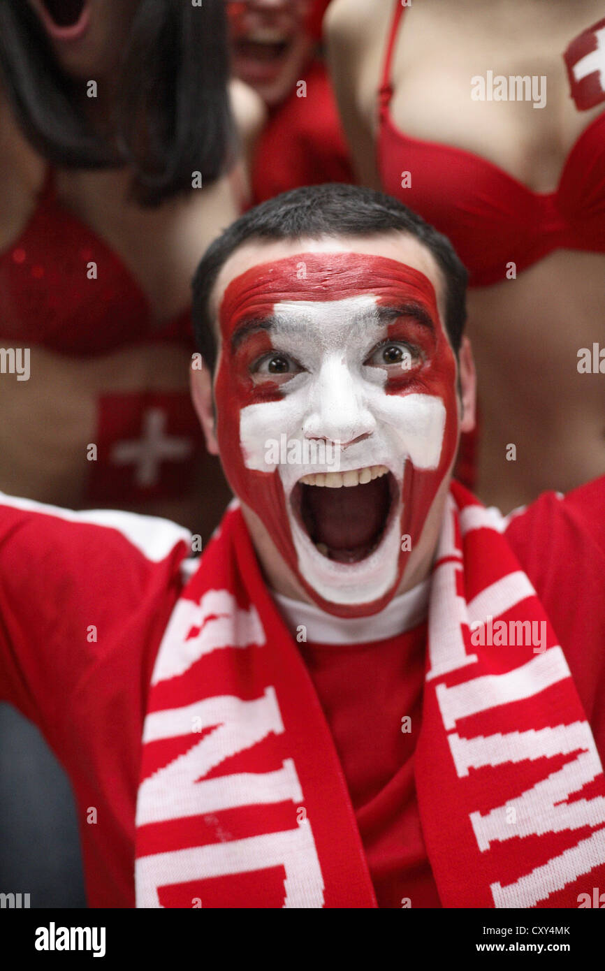Screaming young man, football fan with a painted face, Swiss national ...