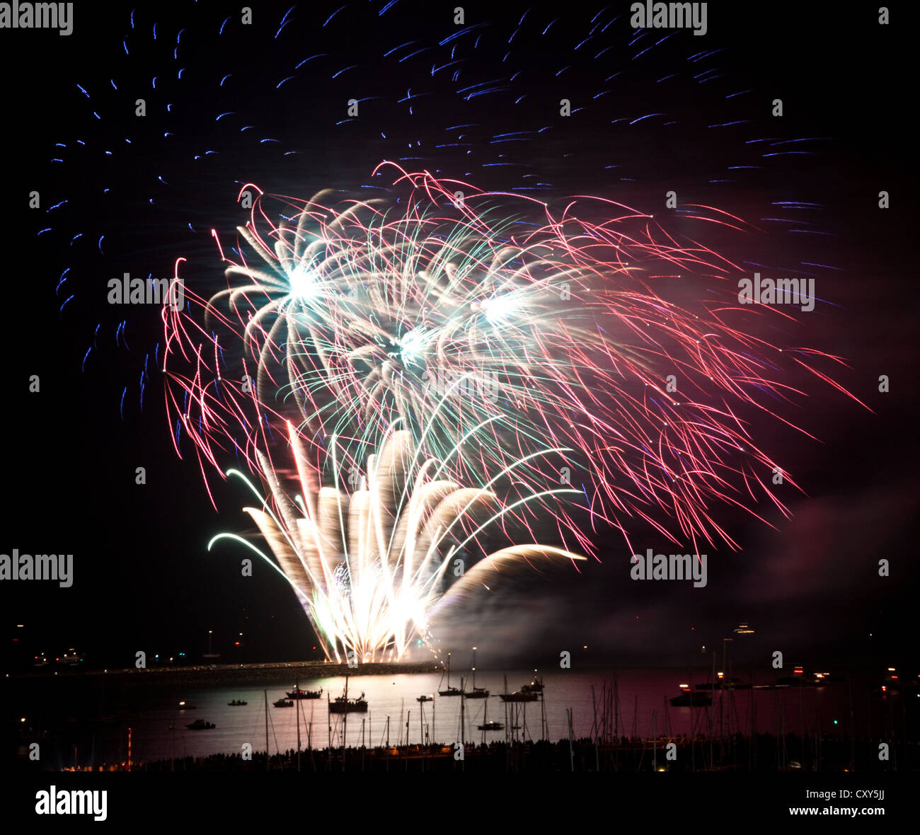 Large firework display over the water, with multi coloured effects ...