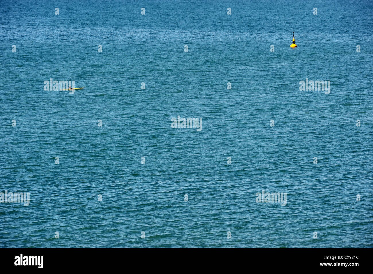 Alone in a Kayak in calm sea wider shot Stock Photo - Alamy