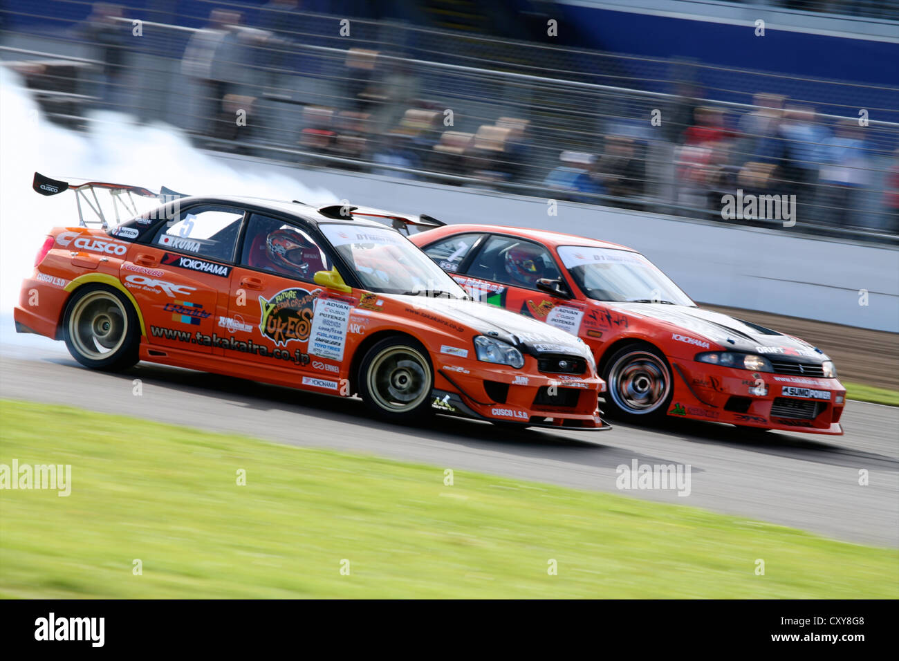 Two drift cars drifting on race track Stock Photo - Alamy