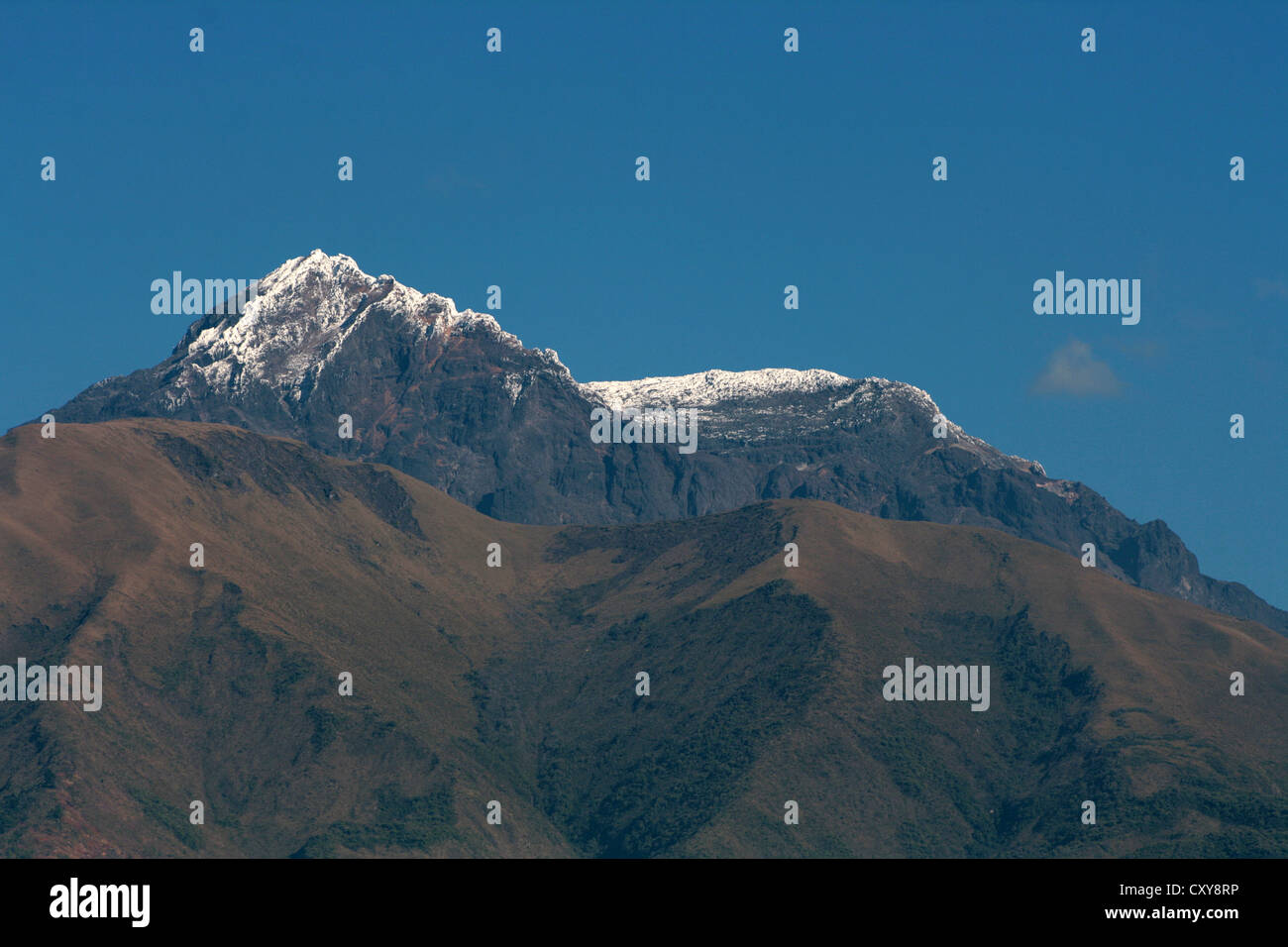 The snow covered summit of the dormant volcano, Mount Cotacachi, as ...