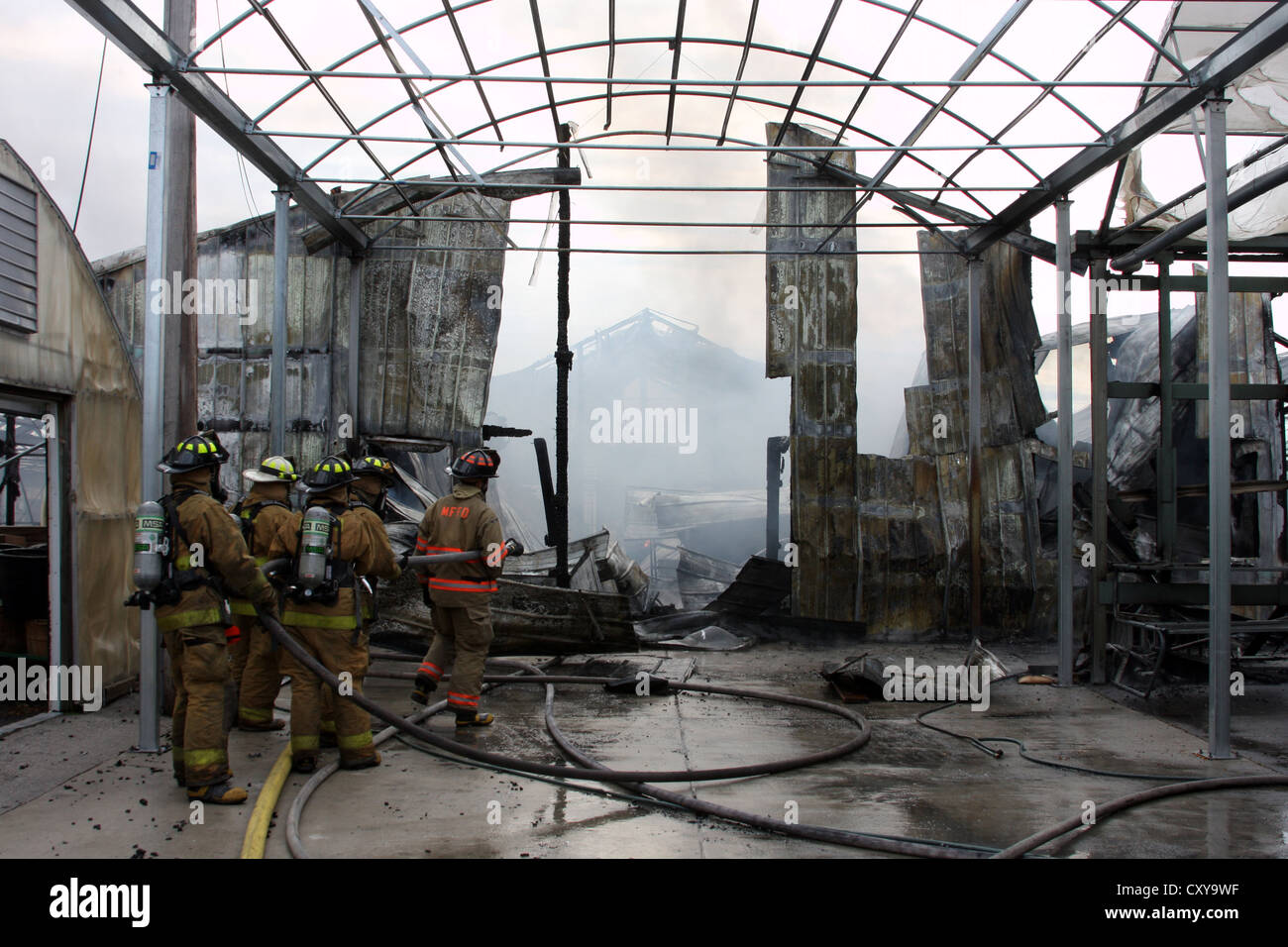 Firefighters on the scene of a greenhouse fire Stock Photo - Alamy