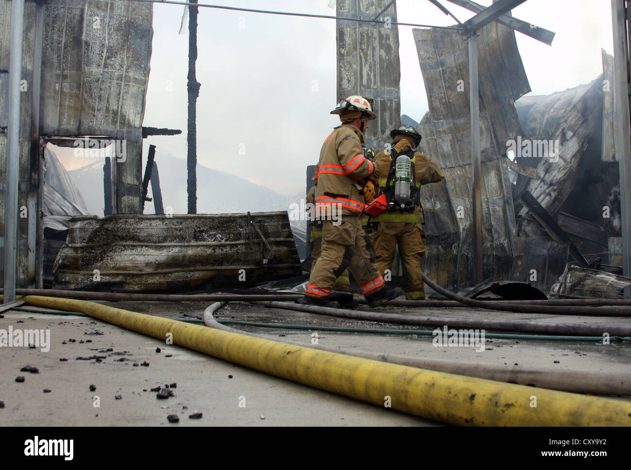 Firefighters fighting a fire in an industrial building in Wisconsin ...