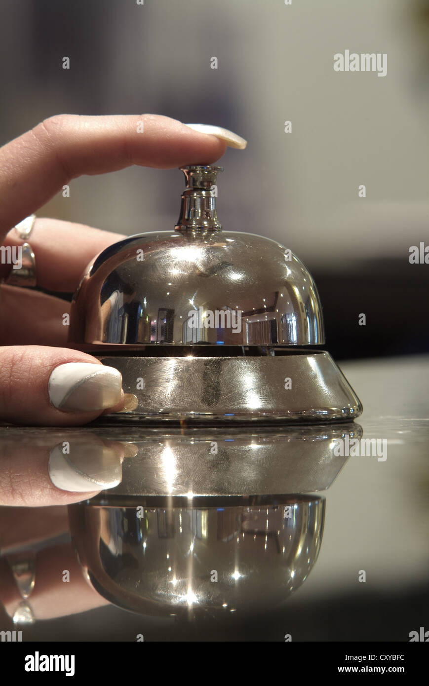 Hand, finger on a hotel reception bell Stock Photo - Alamy