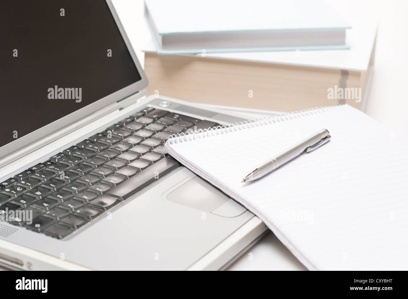 Office desk laptop with notepad and pen on white background Stock Photo ...