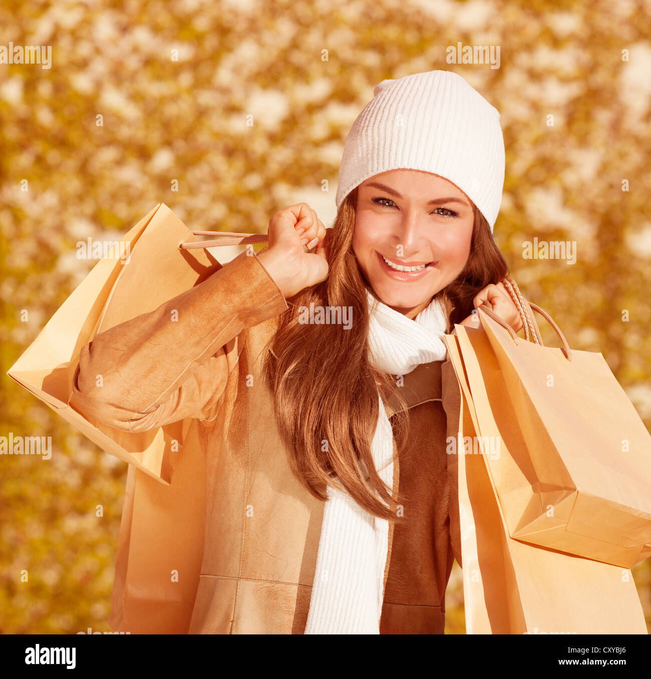 Image of beautiful happy female holding brown paper bag in hands ...
