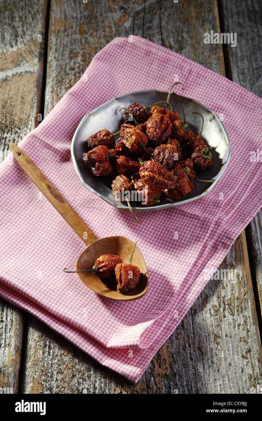 Dried mini-peppers lying on a rustic table Stock Photo - Alamy