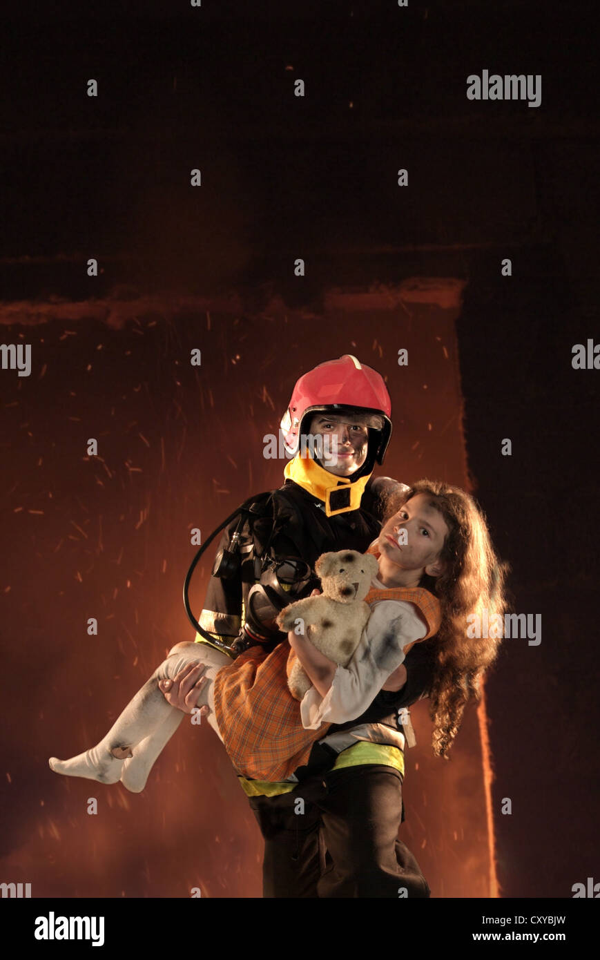 Firefighter rescuing people from building hi-res stock photography and ...