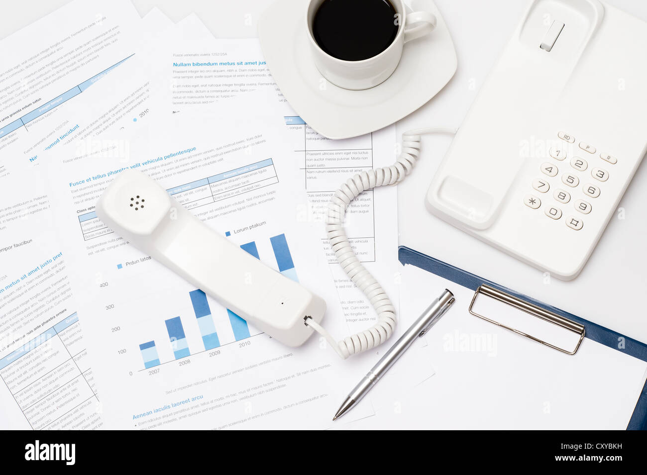 Busy office desk telephone on paper charts business meeting Stock Photo ...
