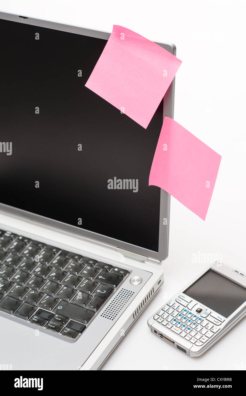 Post-it stickers on business laptop and phone isolated on white Stock ...