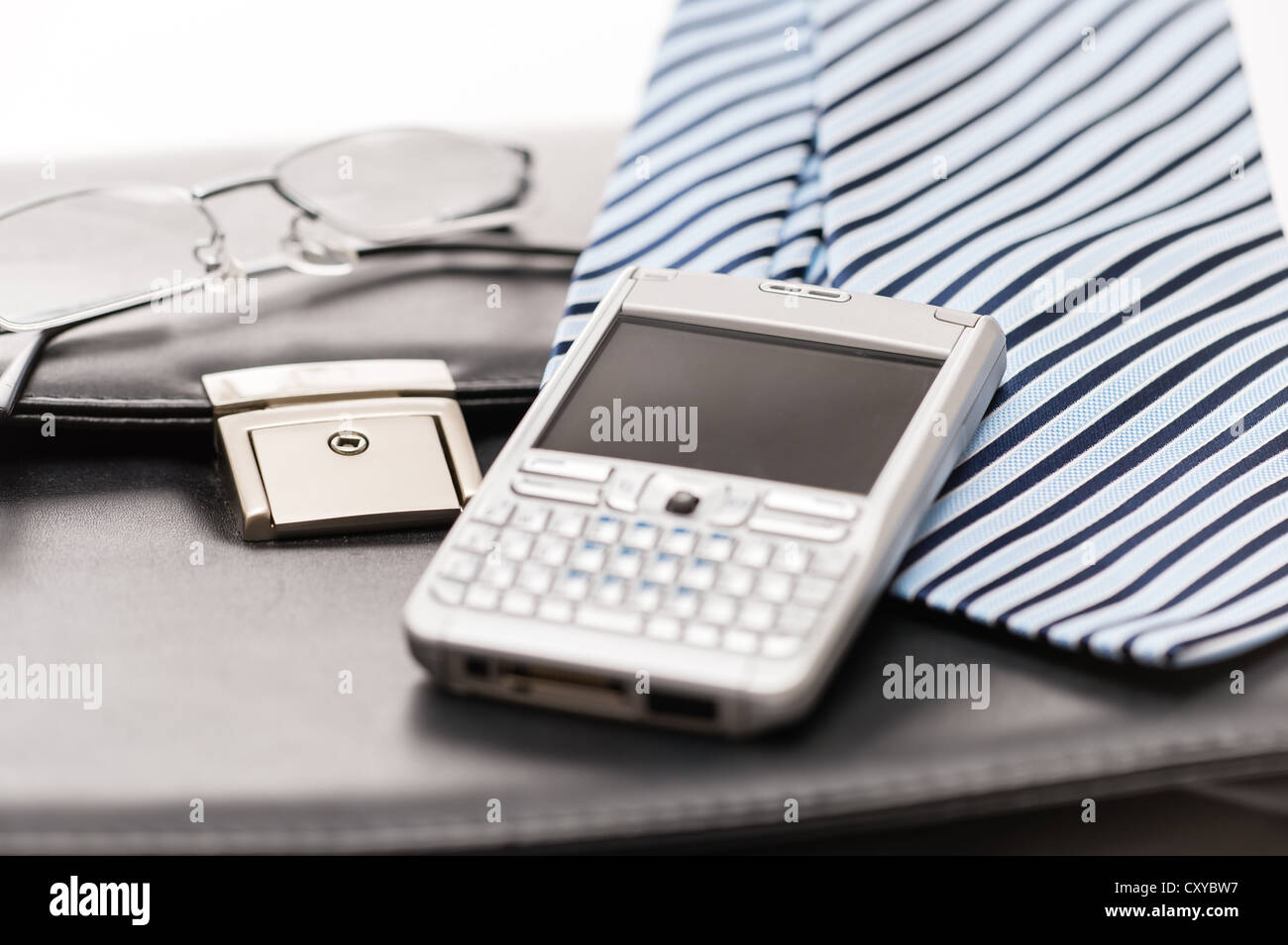 Business mens' accessories tie briefcase phone on white background ...