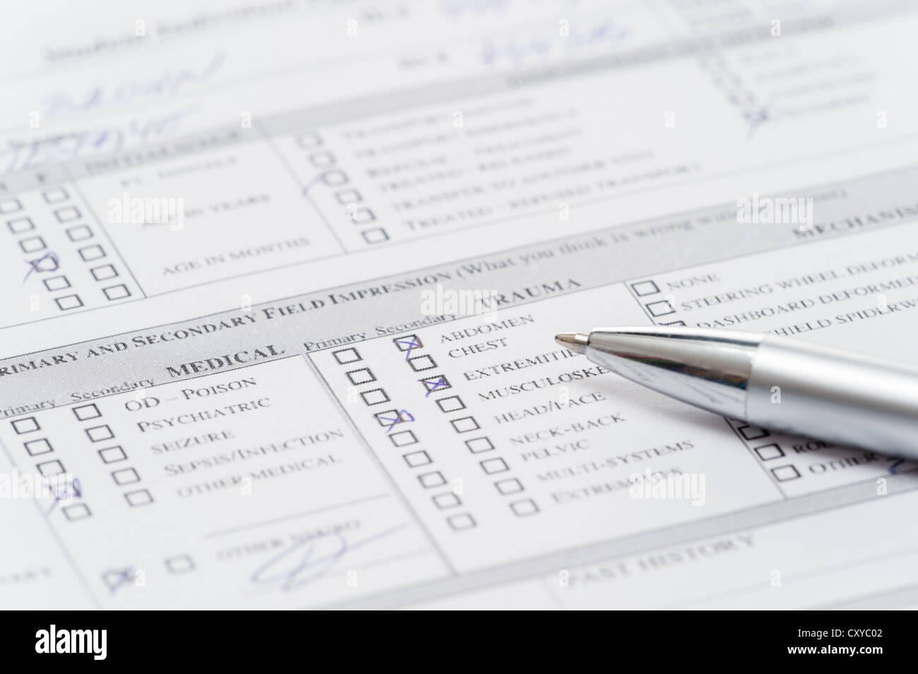 Filling up emergency medical form document pen over chart close-up ...