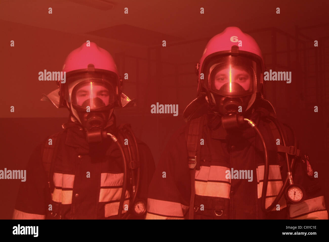 Firefighter wearing protective clothing and breathing masks while on ...