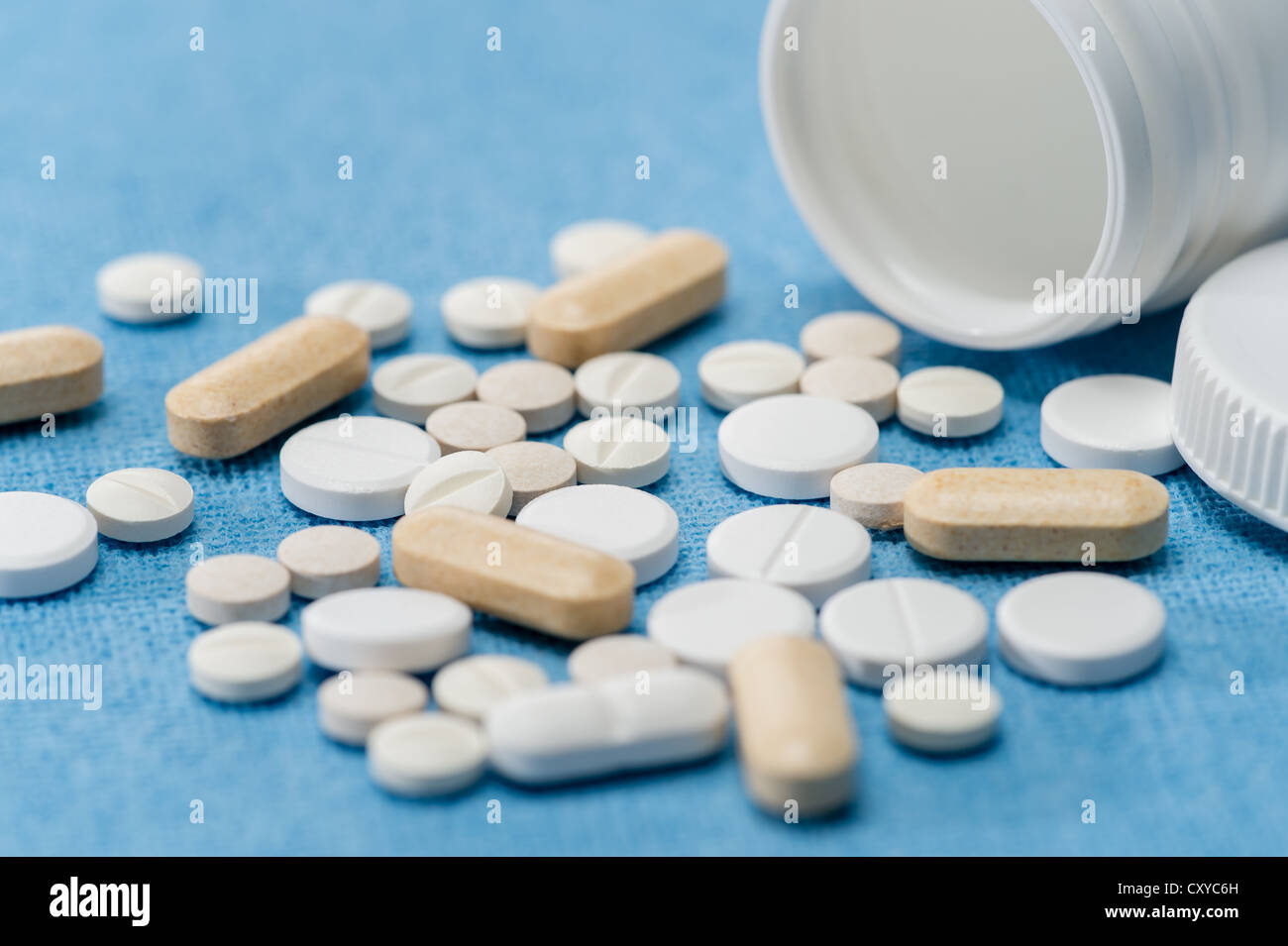 Medicament pills spilled capsules from bottle on medical blue ...