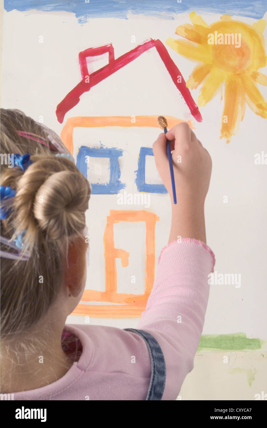 Girl painting a house Stock Photo - Alamy