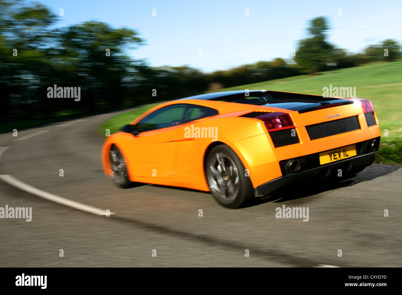 Rear 3/4 of Lamborghini Gallardo driving around corner Stock Photo - Alamy