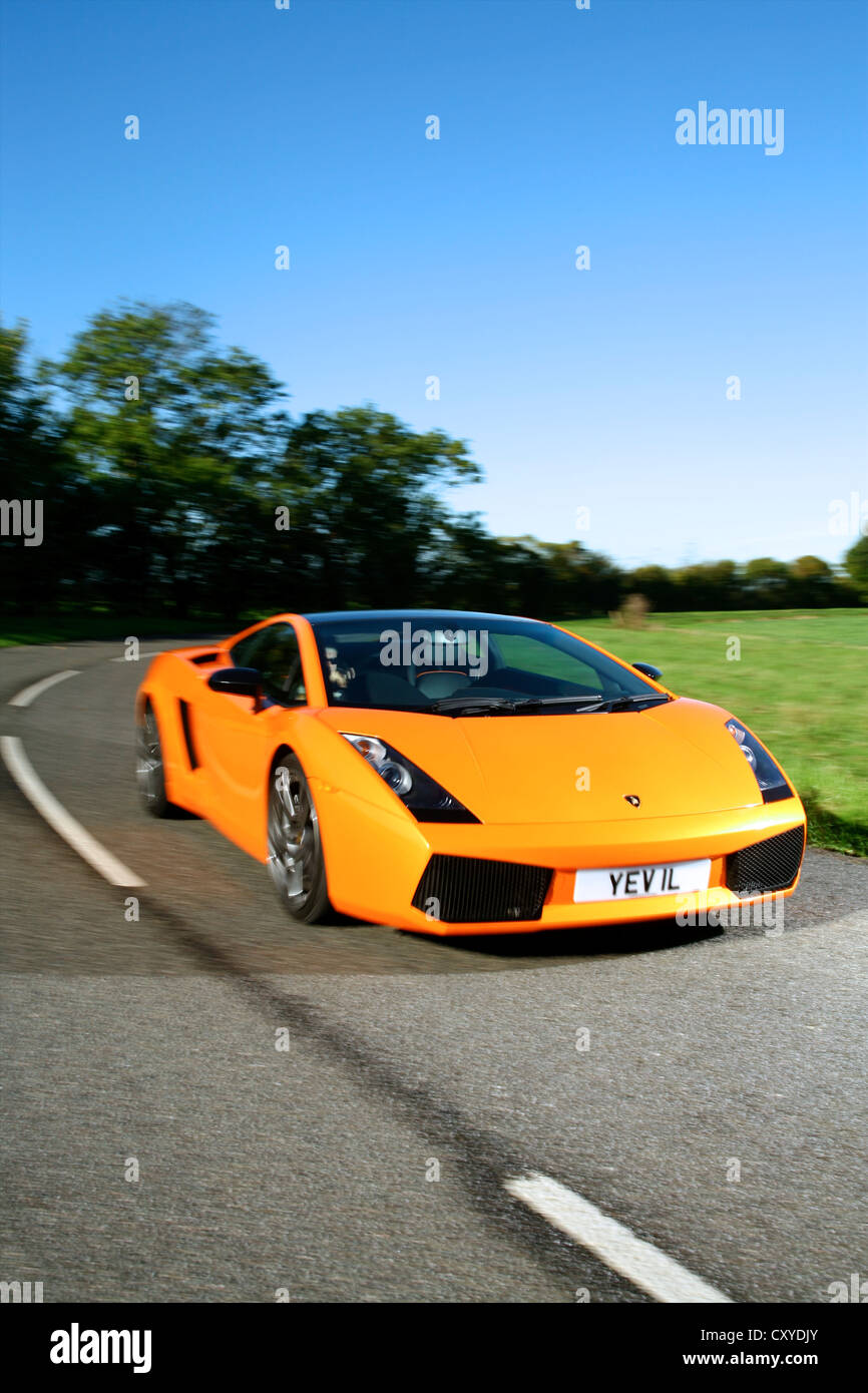Front 3/4 portrait of Lamborghini Gallardo driving around corner Stock ...