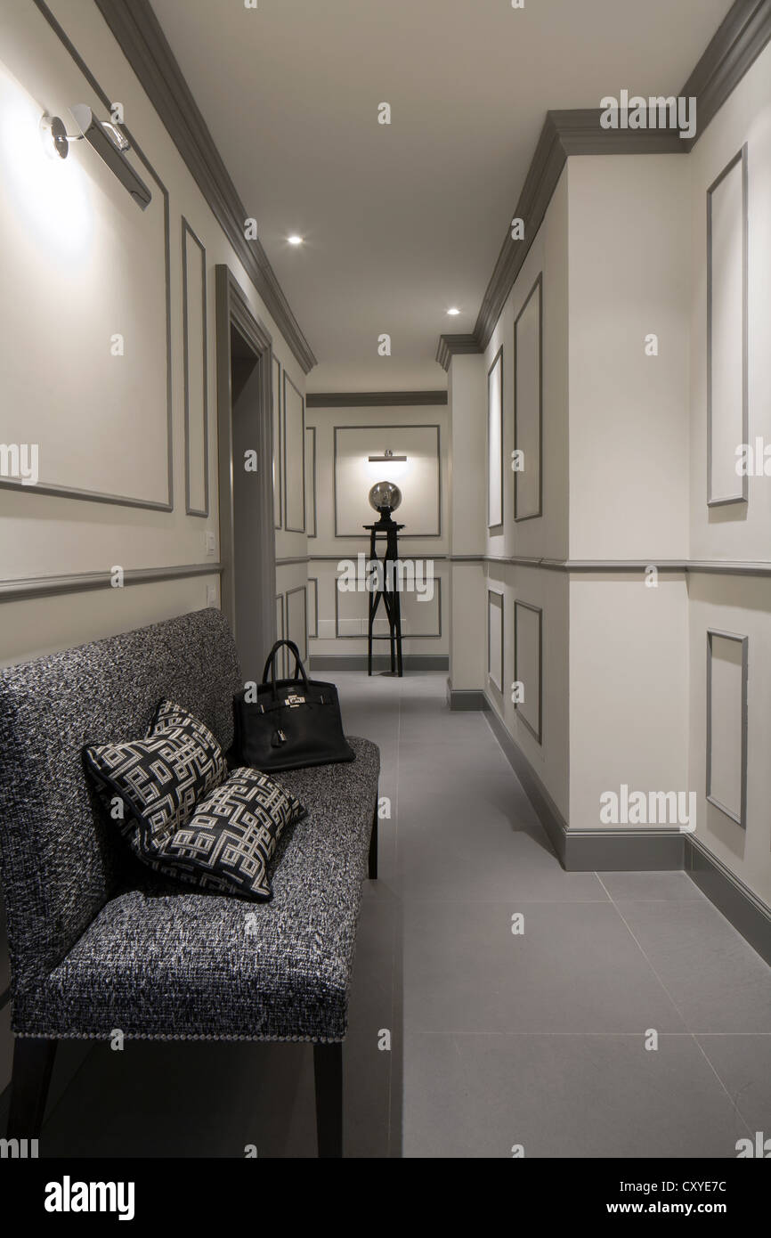 Corridor, passage way, in an elegant house in Italy with a small sofa ...