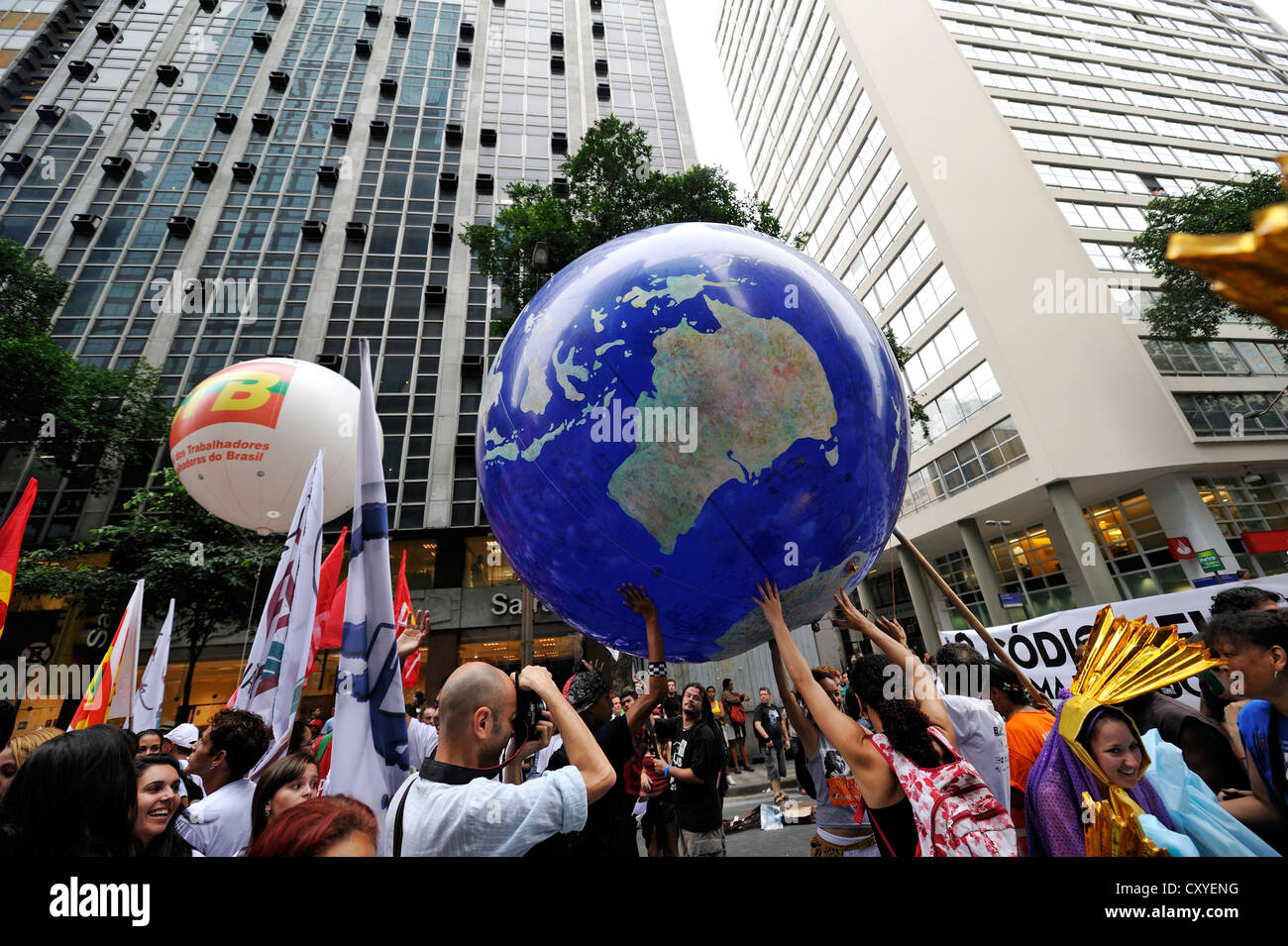 Demonstrators holding a giant balloon, globe into the air ...