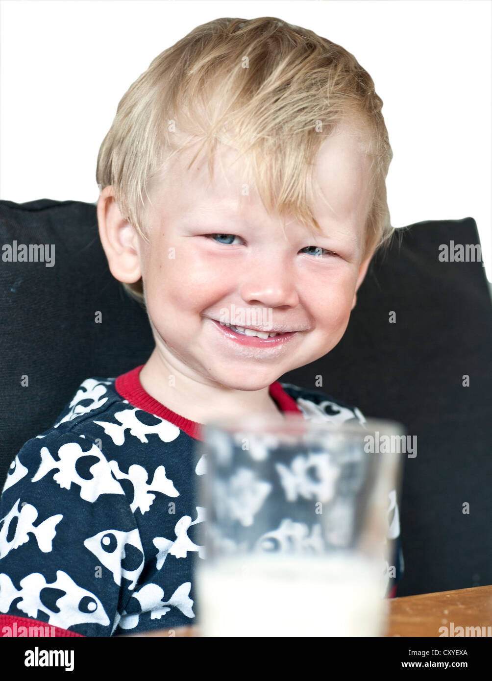 Young boy smiling after a sip of milk Stock Photo - Alamy