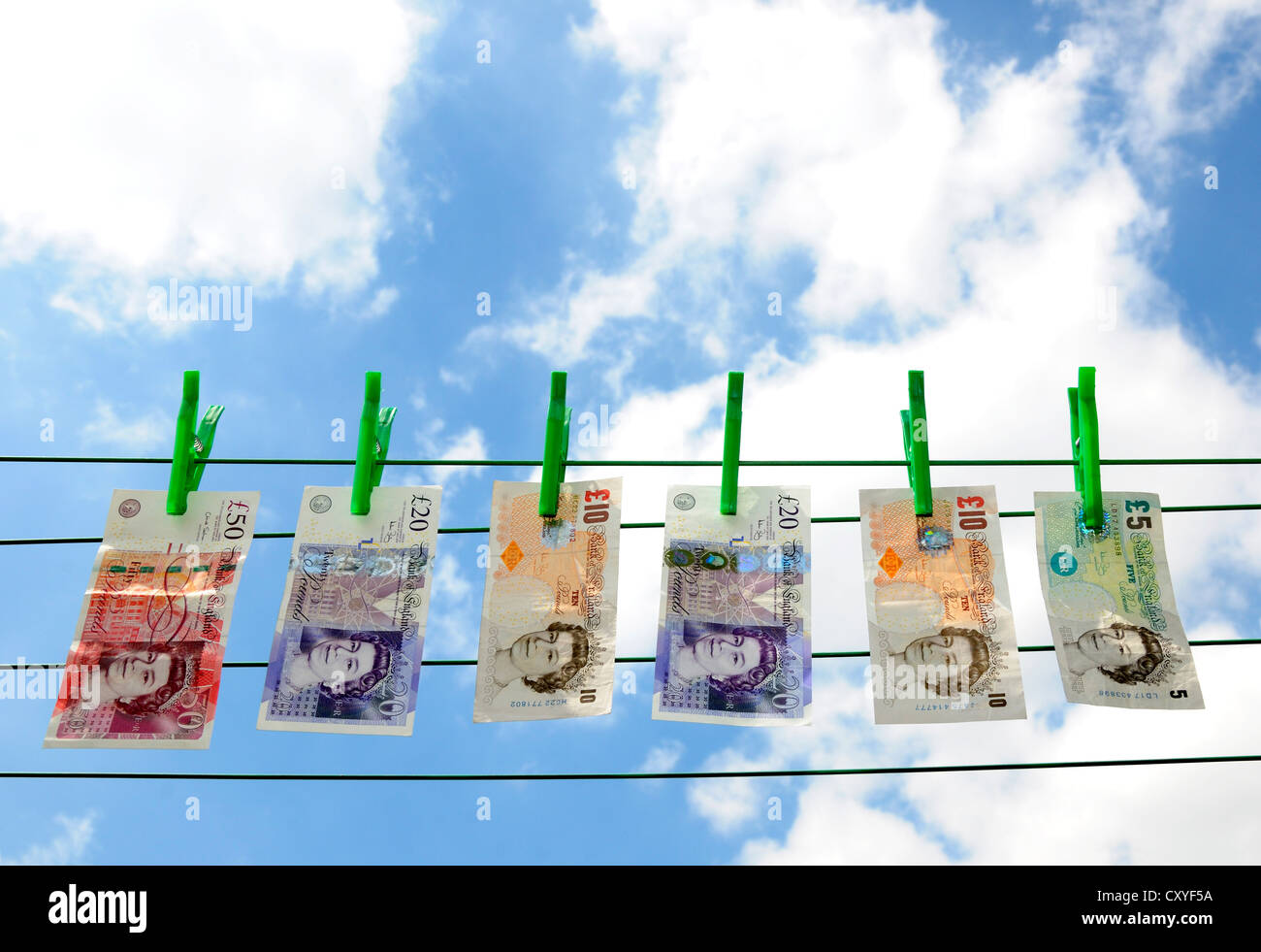 UK bank notes hanging on a washing line Stock Photo - Alamy