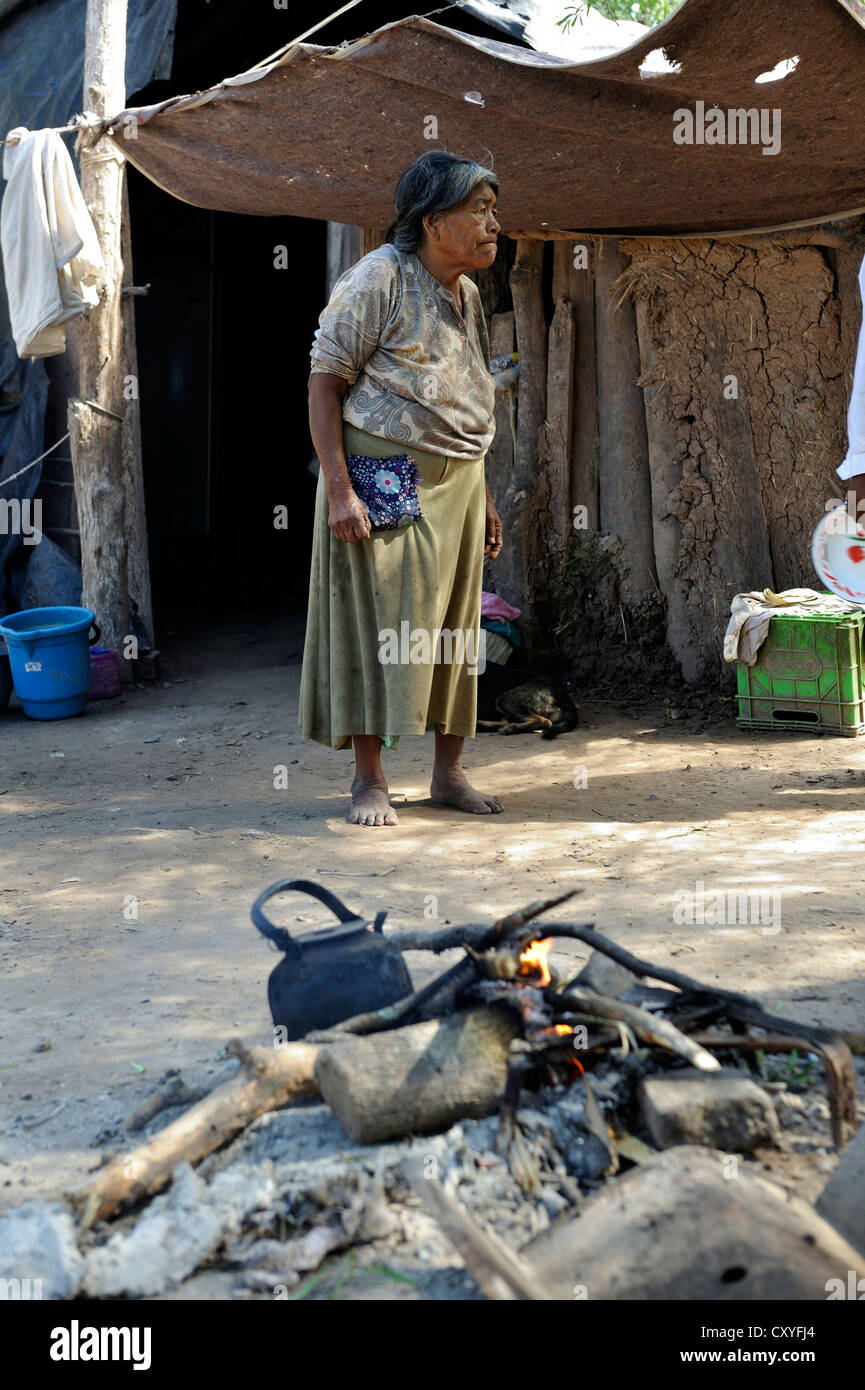 Old indigene women sitting in front of her simple hut, village of the ...