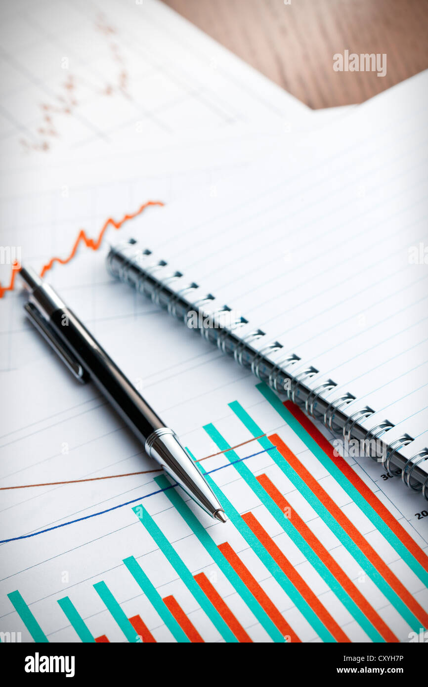 pen and blank notebook on a business graph Stock Photo - Alamy