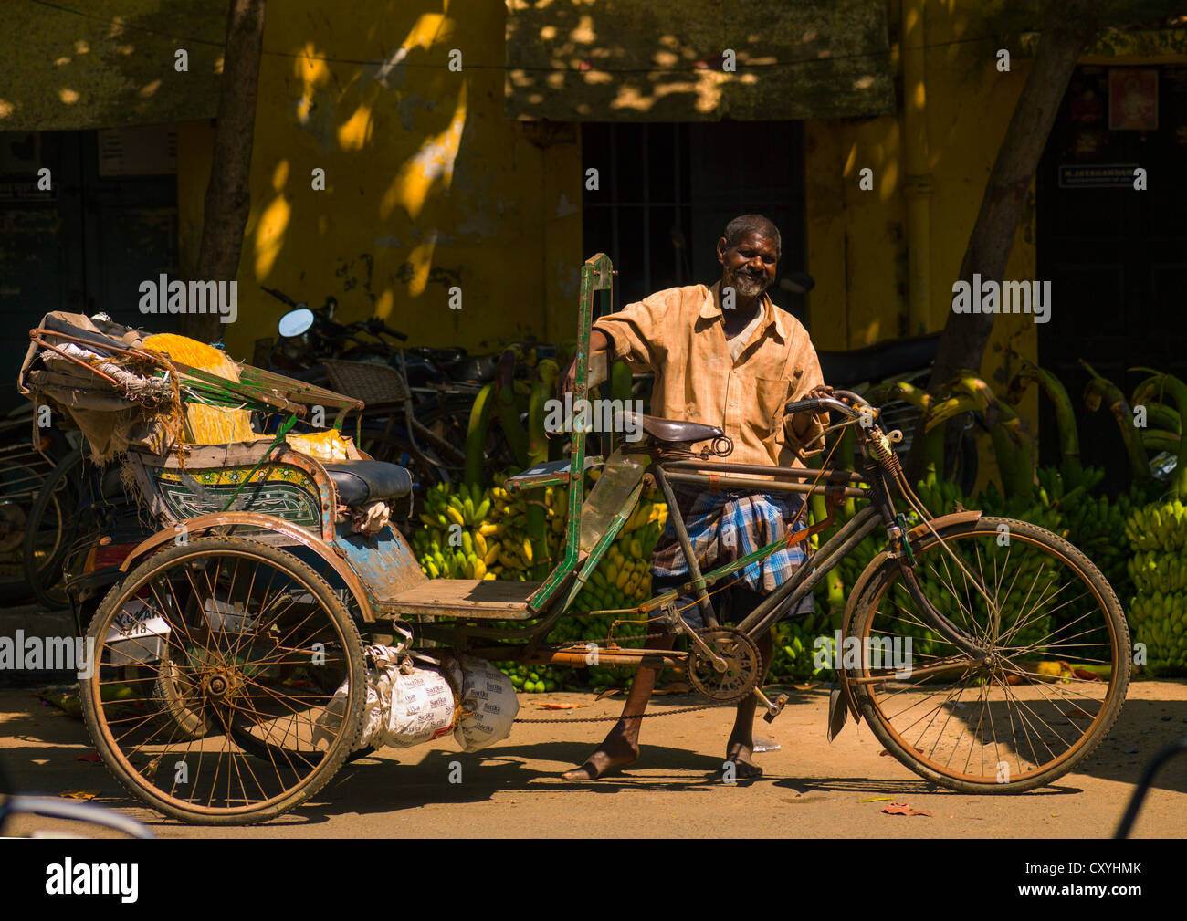 Cycle Rickshaw Driver Posing In Front Of Bunches Of Bananas In A Street ...
