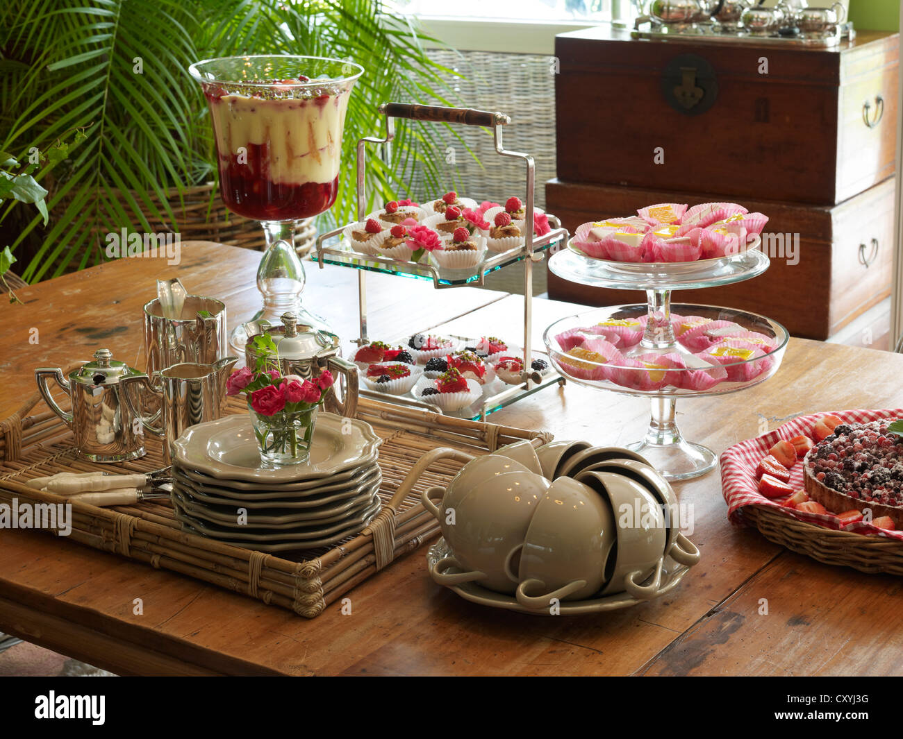 Stylish decorated coffee table in a romantic setting with fruit pudding ...