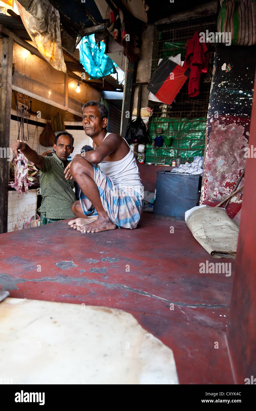 Crouching Man in Kolkata, India Stock Photo - Alamy