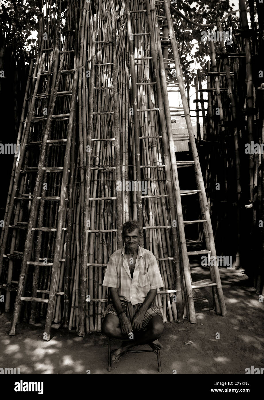 Old Amused Indian Man Sitting In The Shade Of Trees In Front Of Wooden ...