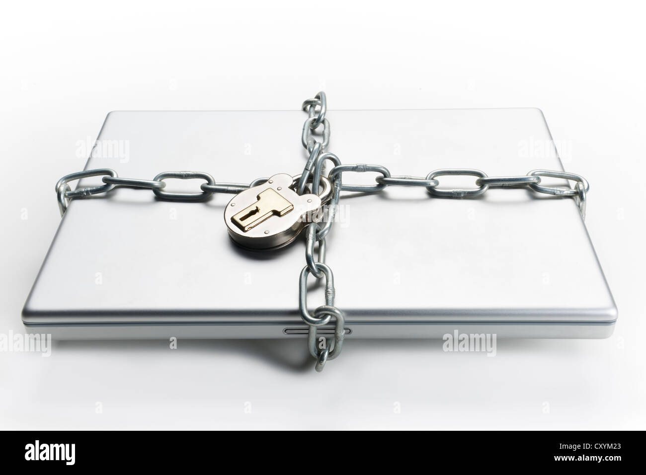 Closed laptop computer with chain wrapped around it and padlocked Stock ...