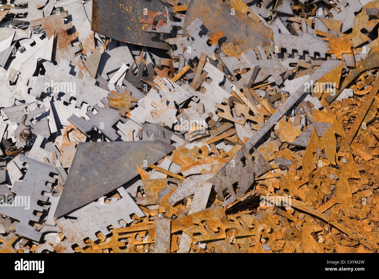 Assorted white and rusted metal brackets at a scrap metal recycling ...