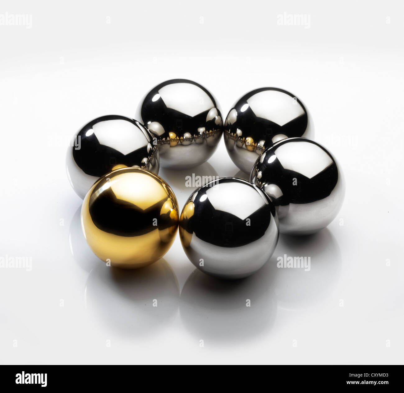 One golden and five silver-coloured metall balls in a circle Stock ...