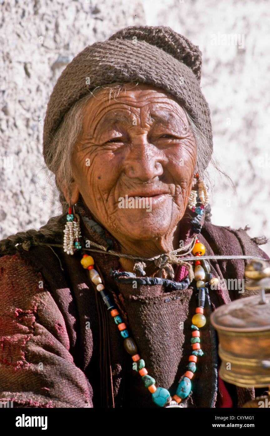 Old Ladakhi lady turning her praying mill, Lamayuru, India, Asia Stock ...