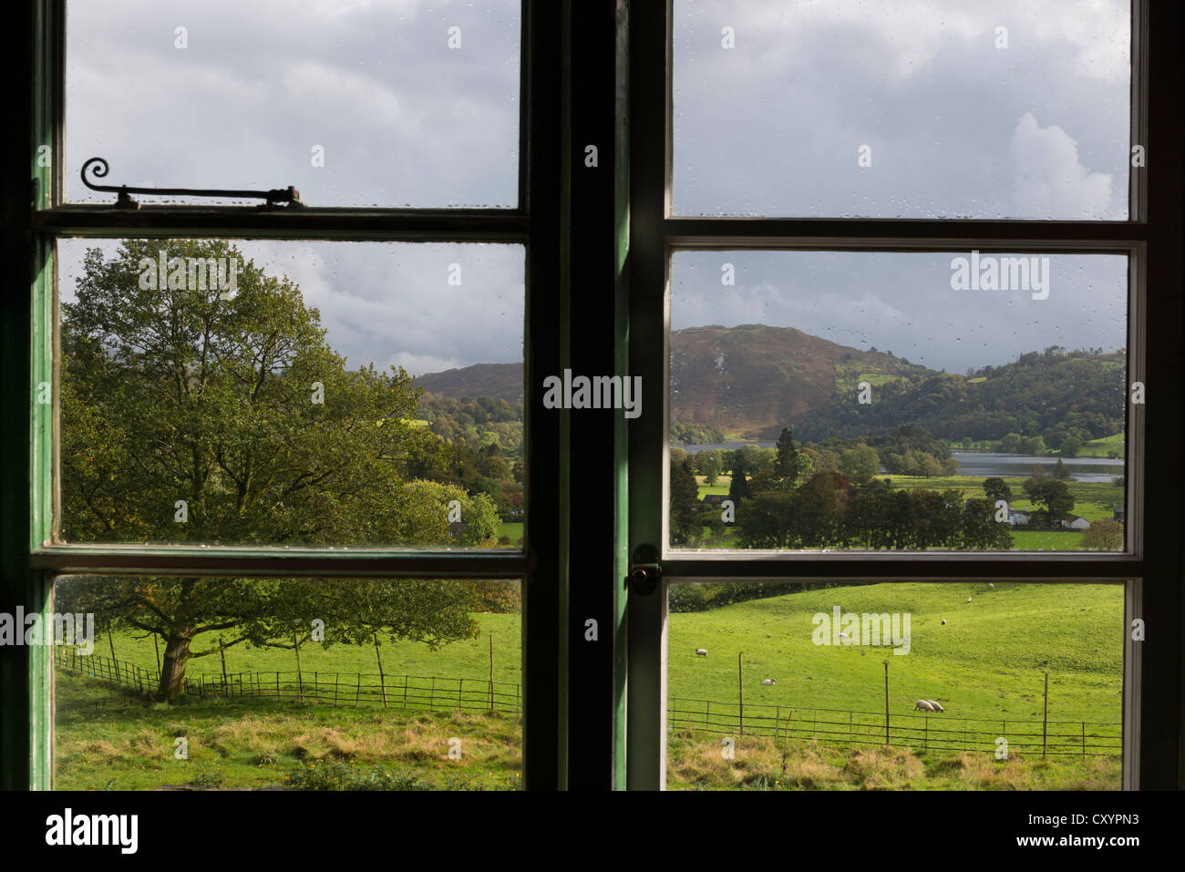 Sunny and cloudy view over Grasmere, Lake District, through a window ...